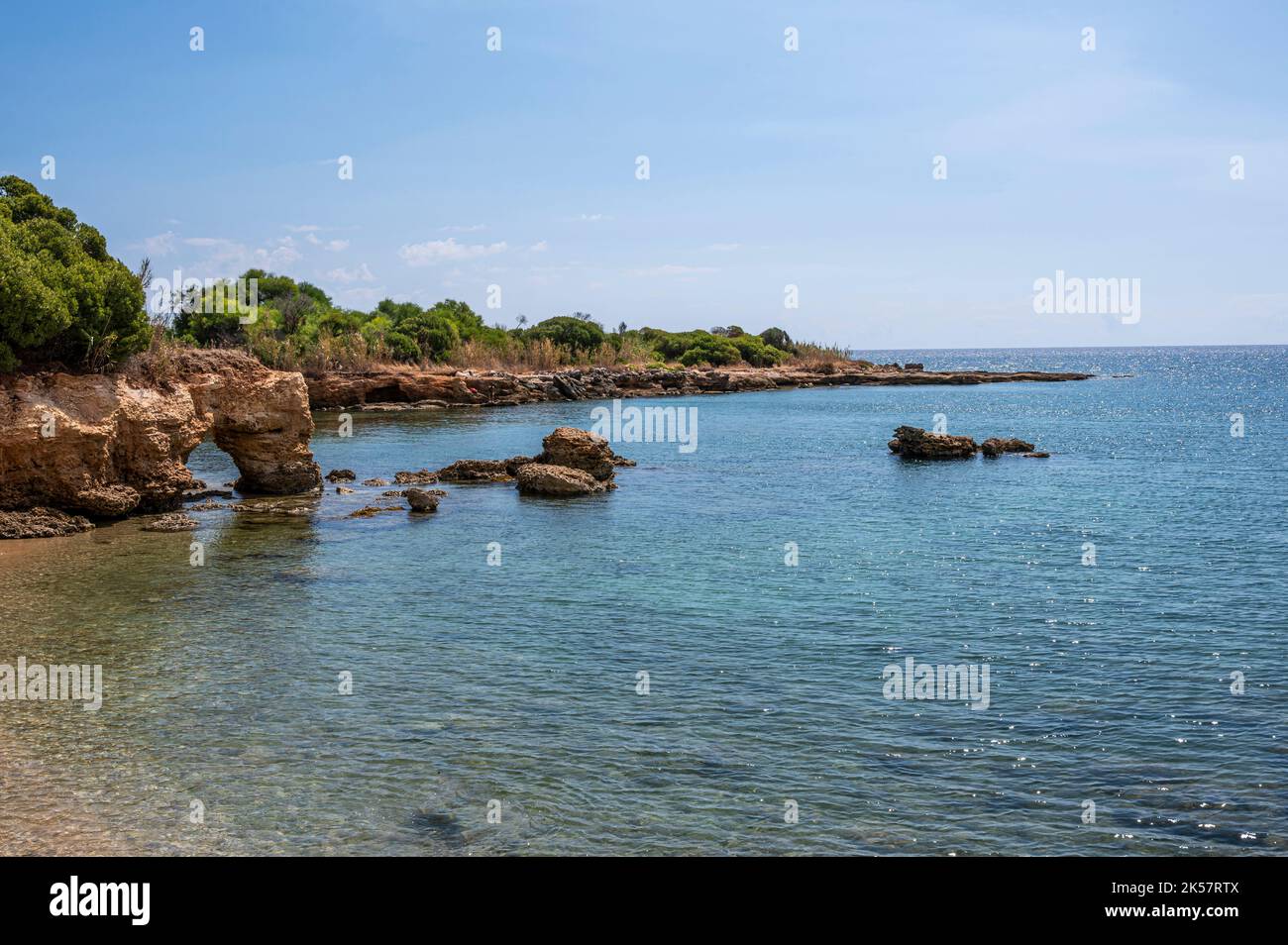 Beautiful beach with crystal clear water and a natural rock arch in ...