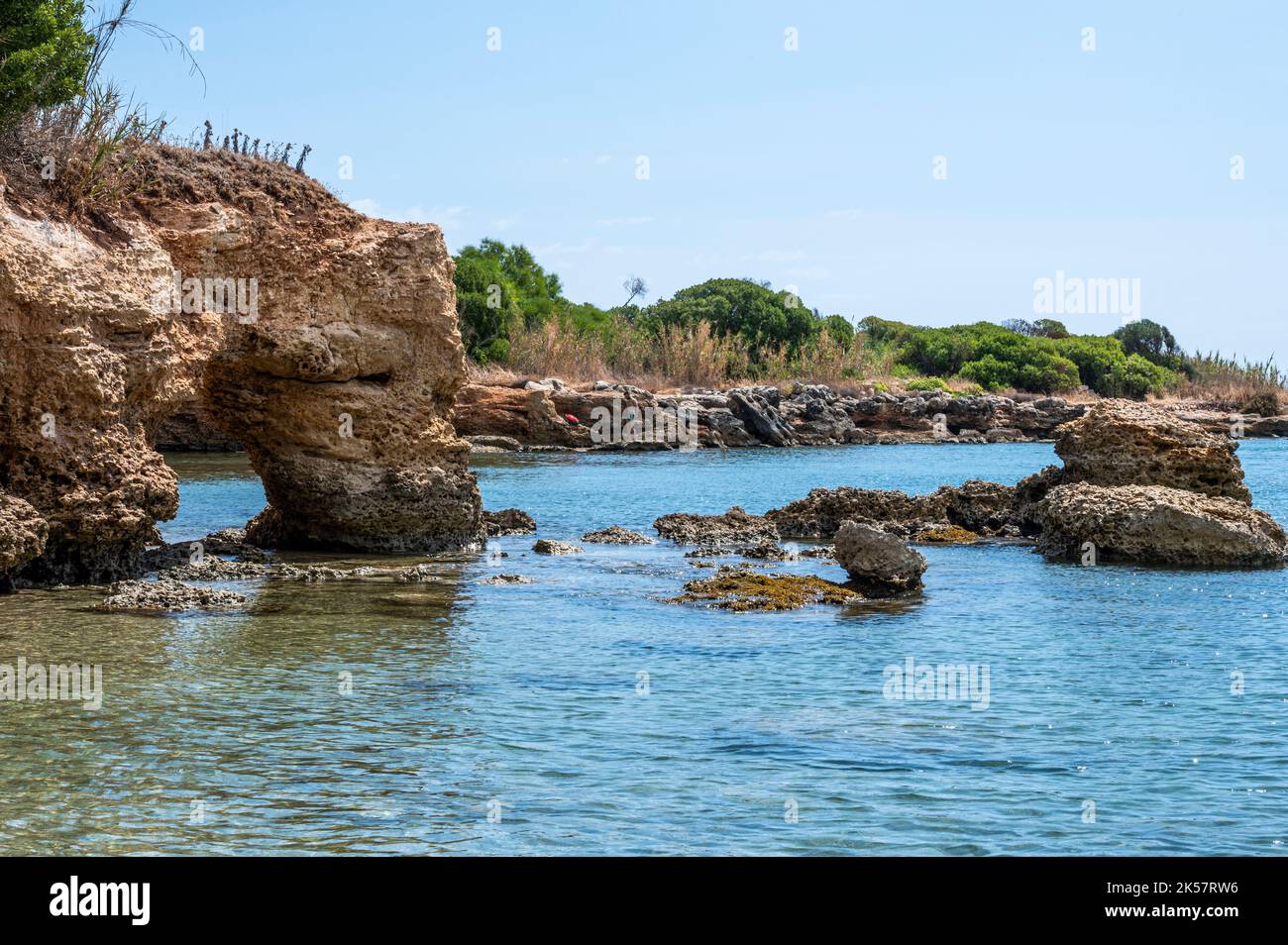 Beautiful beach with crystal clear water and a natural rock arch in ...