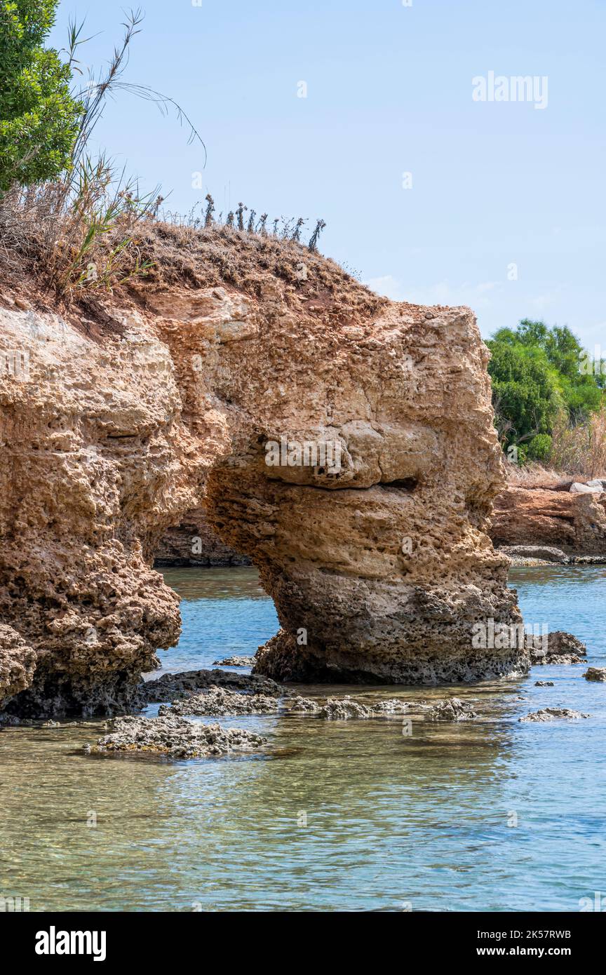 Beautiful beach with crystal clear water and a natural rock arch in ...