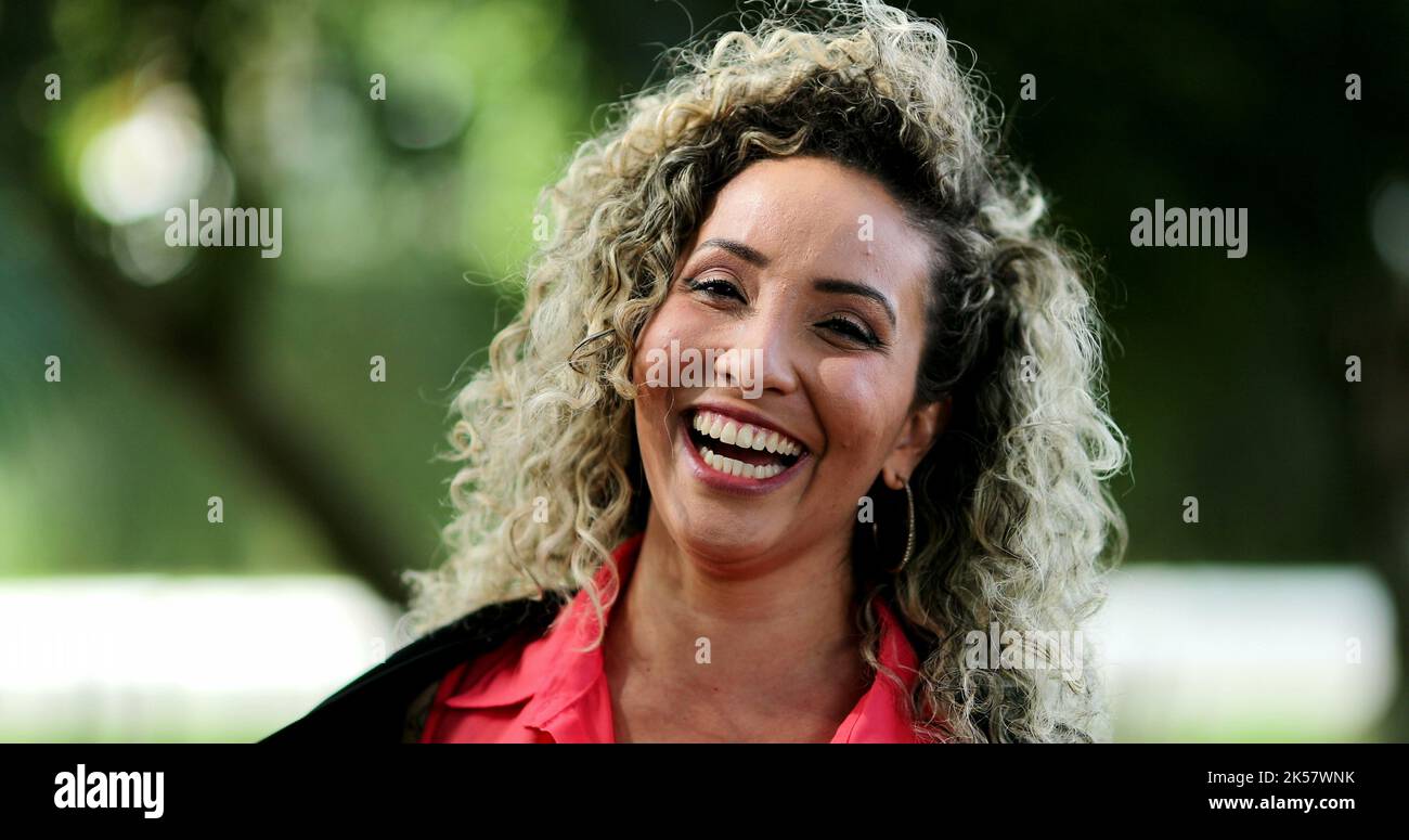 Happy hispanic woman laughing outside. Casual latin person, south ...