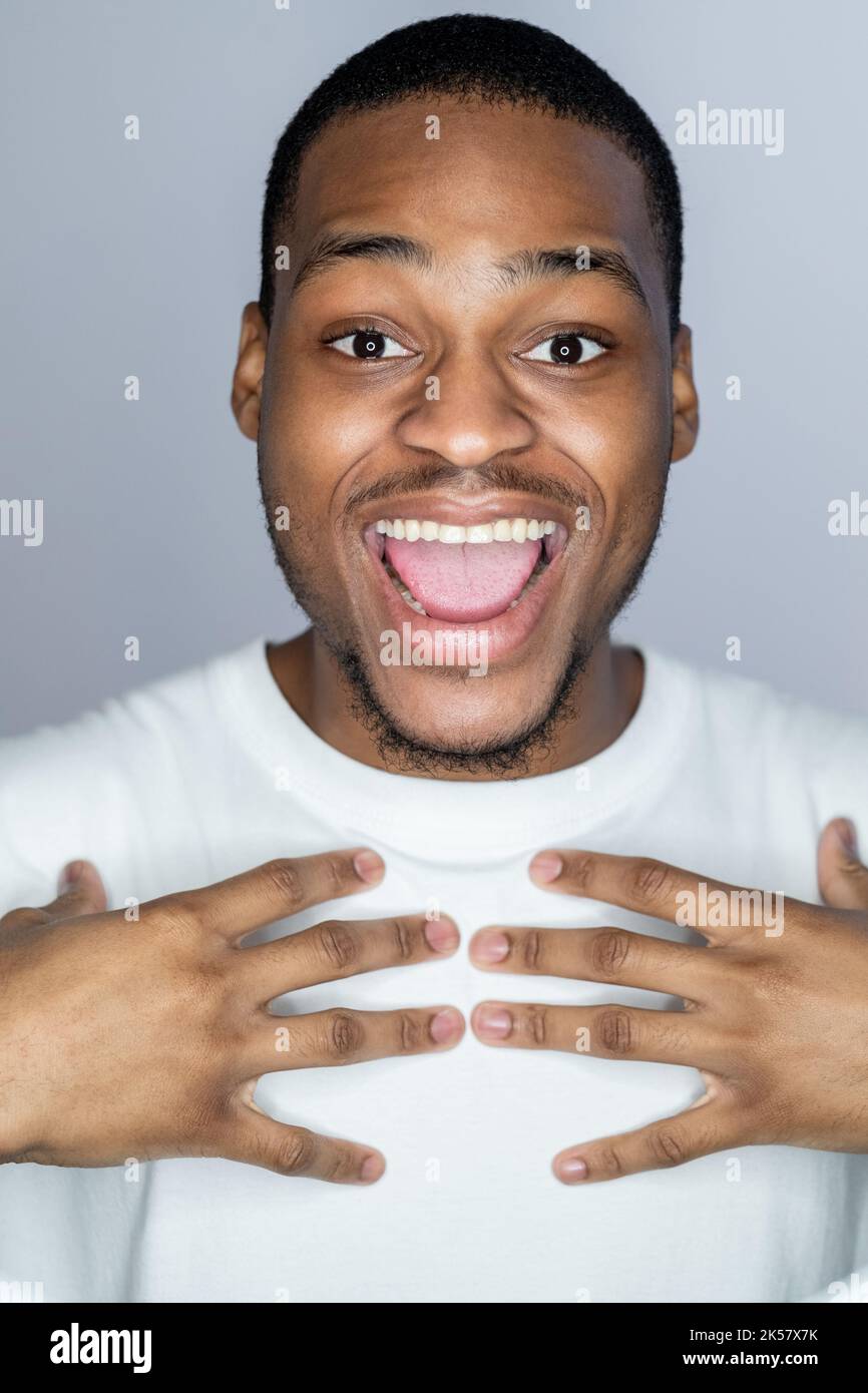 Happy African man. Self acceptance admiration. Skincare treatment. Portrait of astonished ...