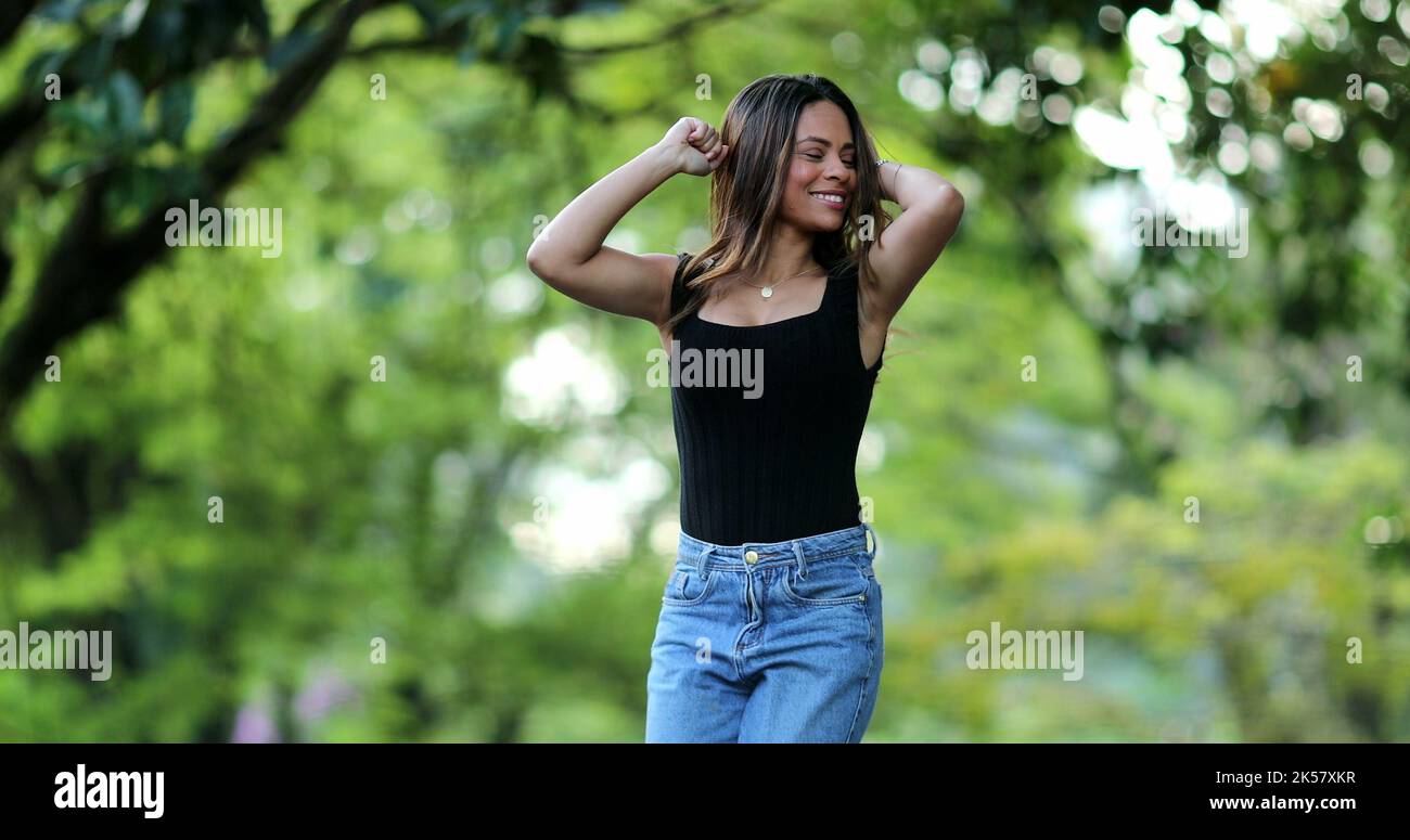 Happy girl celebrating success achievement, woman raising arms in air ...