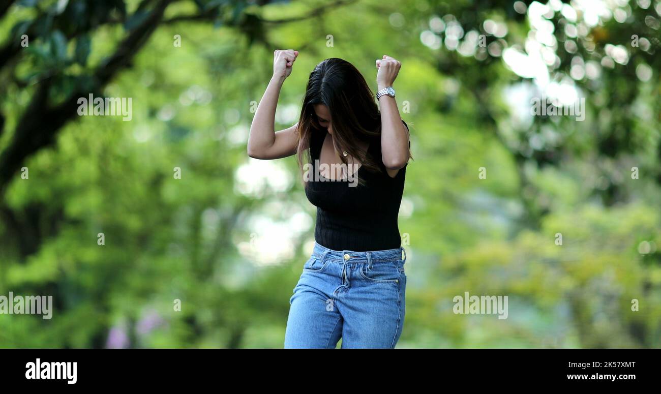 Happy girl celebrating success achievement, woman raising arms in air ...