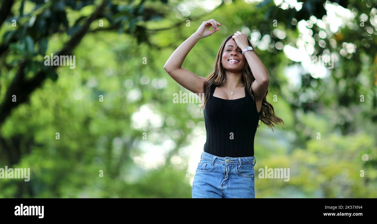 Happy girl celebrating success achievement, woman raising arms in air ...