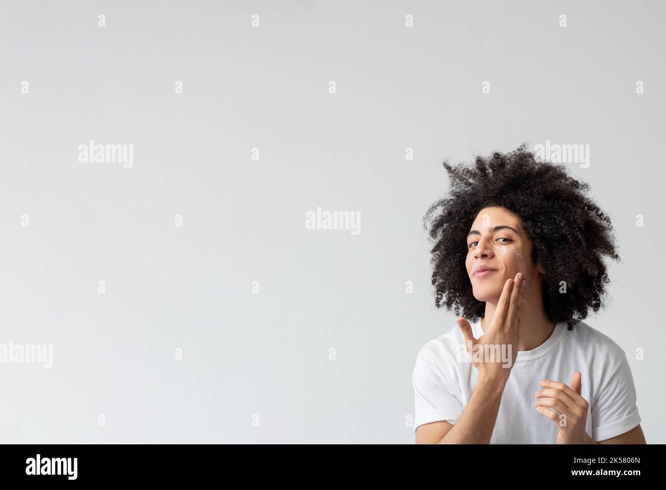 Man skincare. Facial treatment. Male grooming. Satisfied handsome guy ...