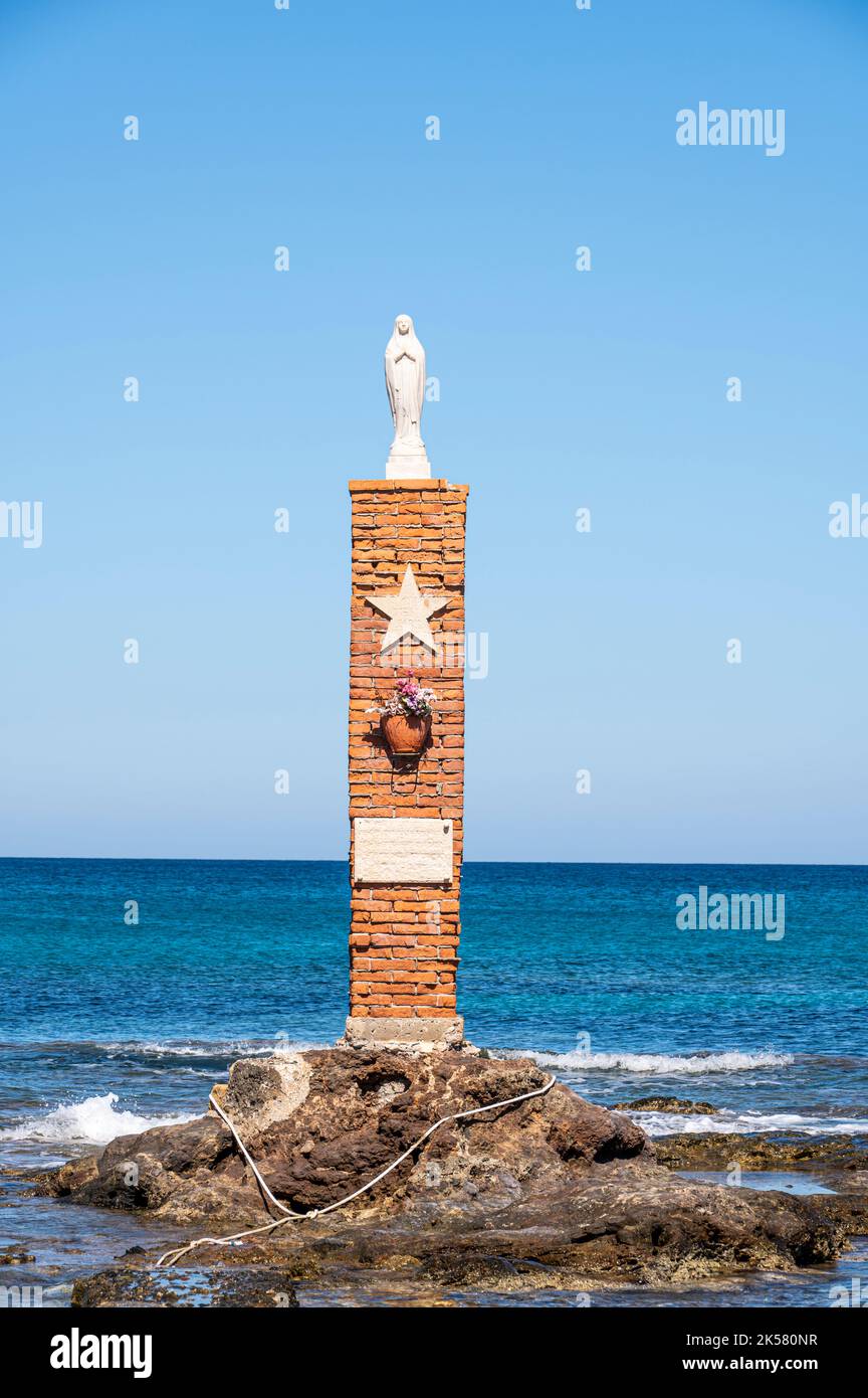 Portopalo, Italy - 09-14-2022: The statue of Maria in the beautiful sea ...