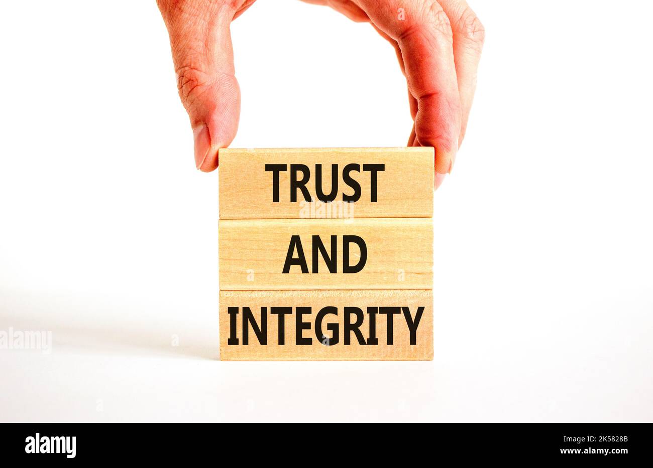 Trust and integrity symbol. Concept words Trust and integrity on wooden ...