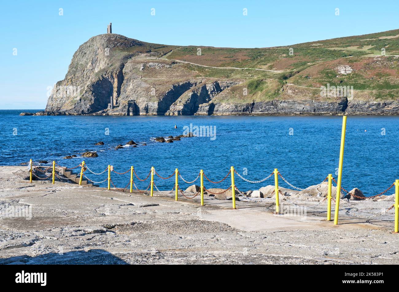 Yellow fence posts mark the edge of a jetty in Port Erin, Isle of Man ...
