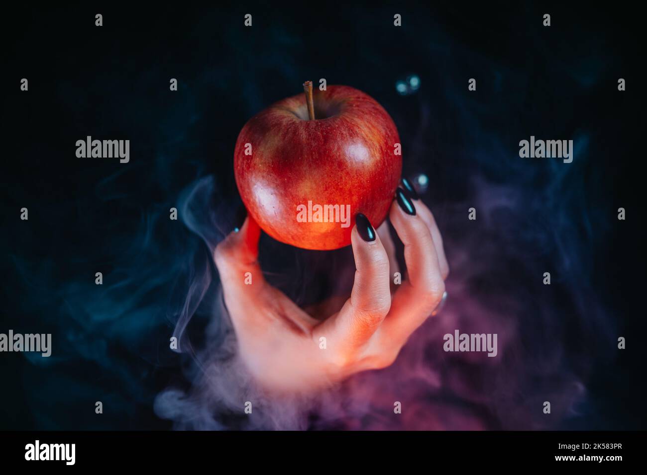 Woman as witch offers red apple as symbol of temptation, poison. Fairy ...