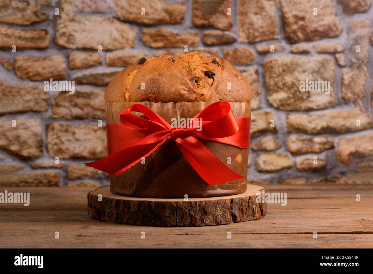 Traditional Italian Christmas Cake Panettone with red bow on wooden ...
