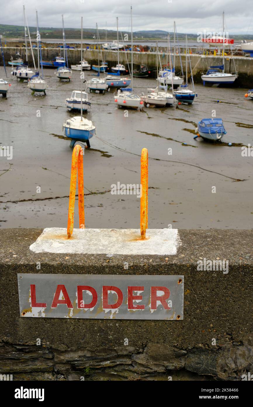 A harbour view with an amusing, labelled ladder in Port St Mary, Isle ...