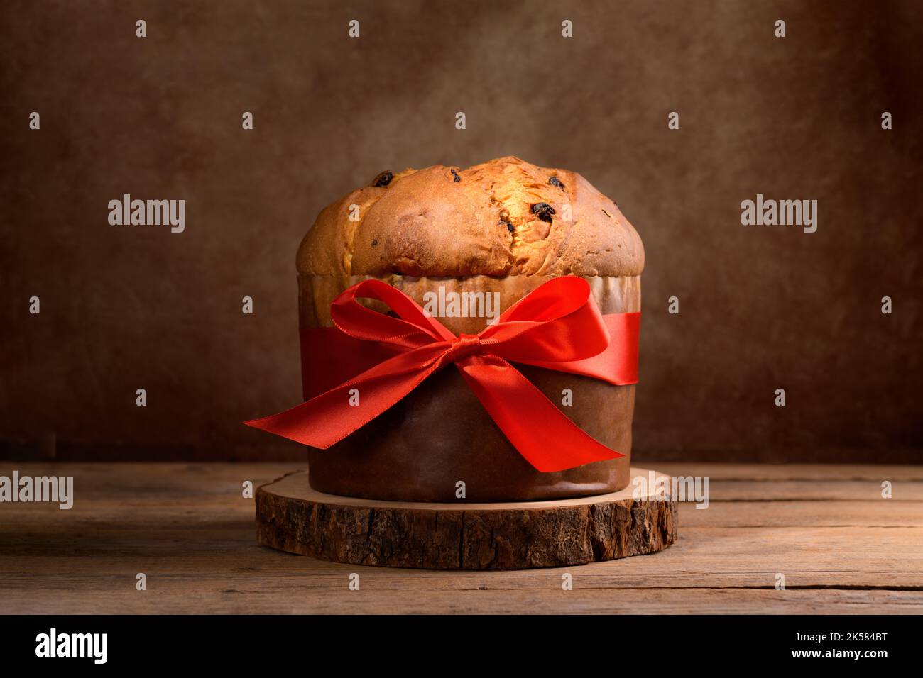 Traditional Italian Christmas Cake Panettone with red bow on wooden ...