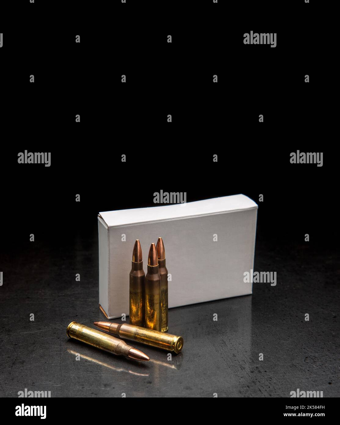 Bullet isolated on black background with reflexion. Rifle bullets close ...