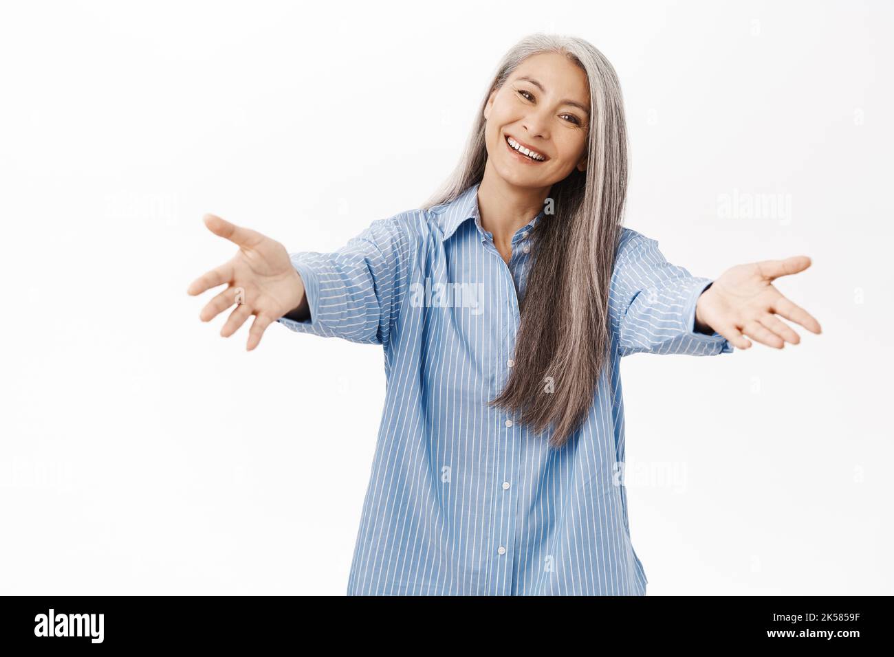 Smiling asian woman reaching hands. Old senior lady stretching out arms ...