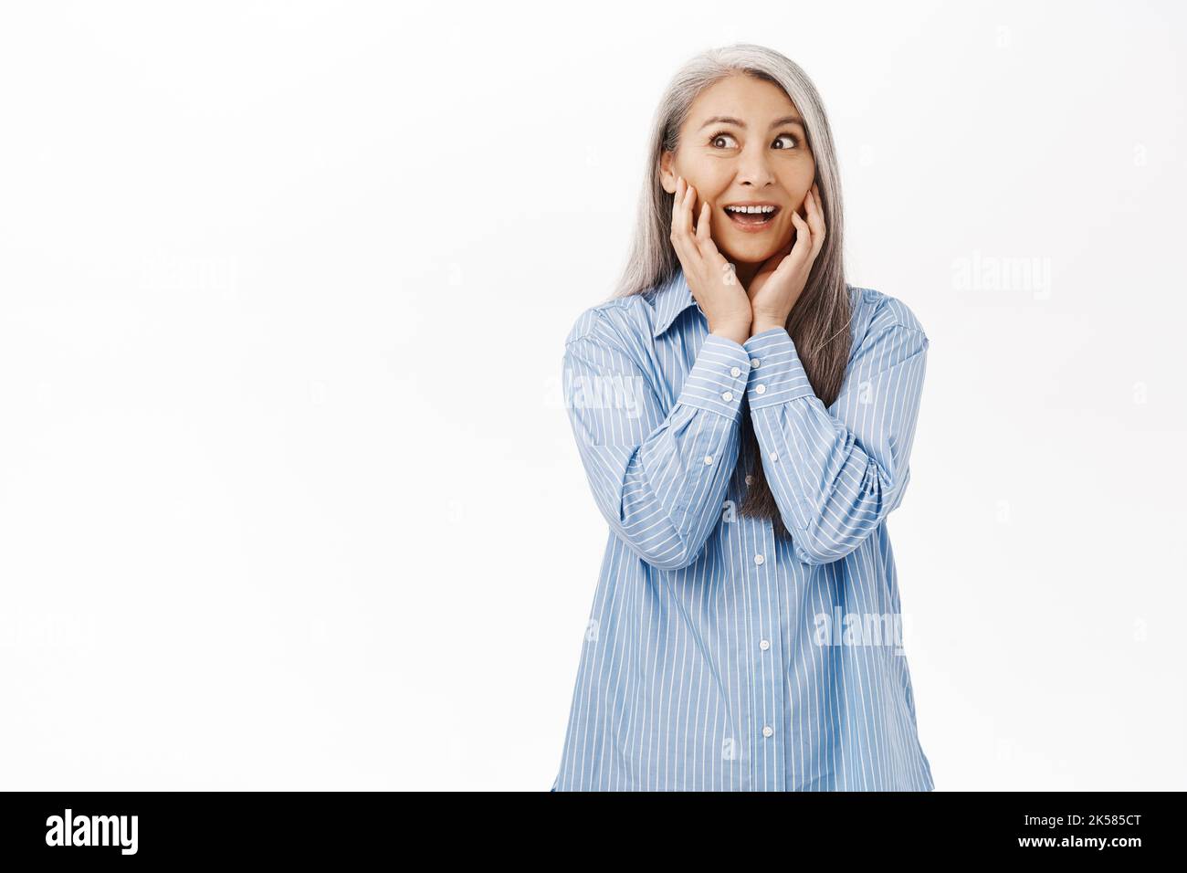 Happy and excited senior woman, korean old lady smiling and looking ...
