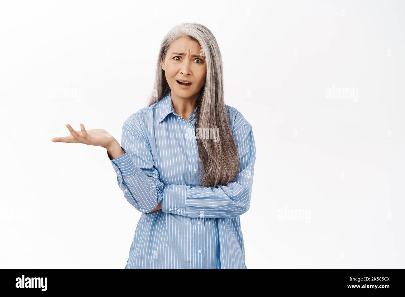 Confused japanese middle aged woman looking questioned and frustrated ...