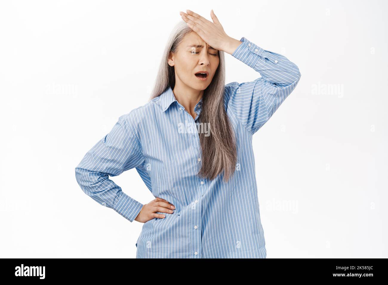 Portrait of troubled senior woman slap forehead, looking upset or ...