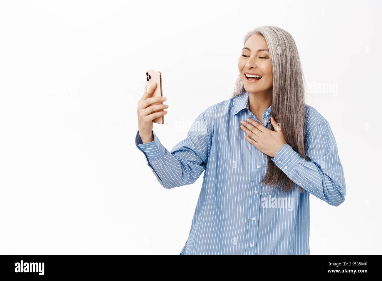Happy asian senior woman, old lady talking on video call, using filter ...