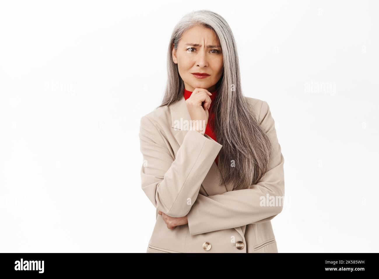 Concerned asian businesswoman, senior corporate lady listening with ...