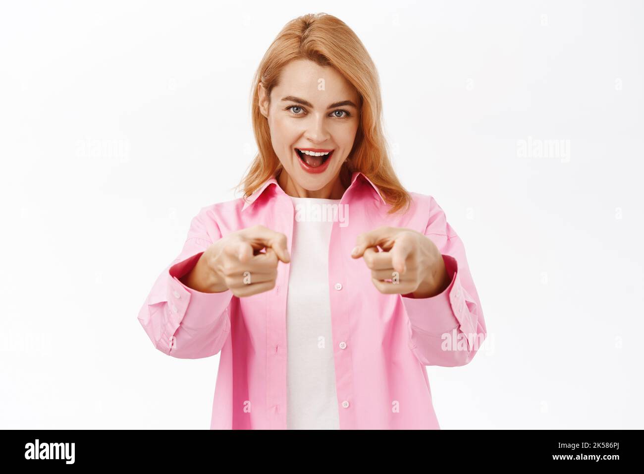 You got this. Smiling young woman pointing fingers at camera ...