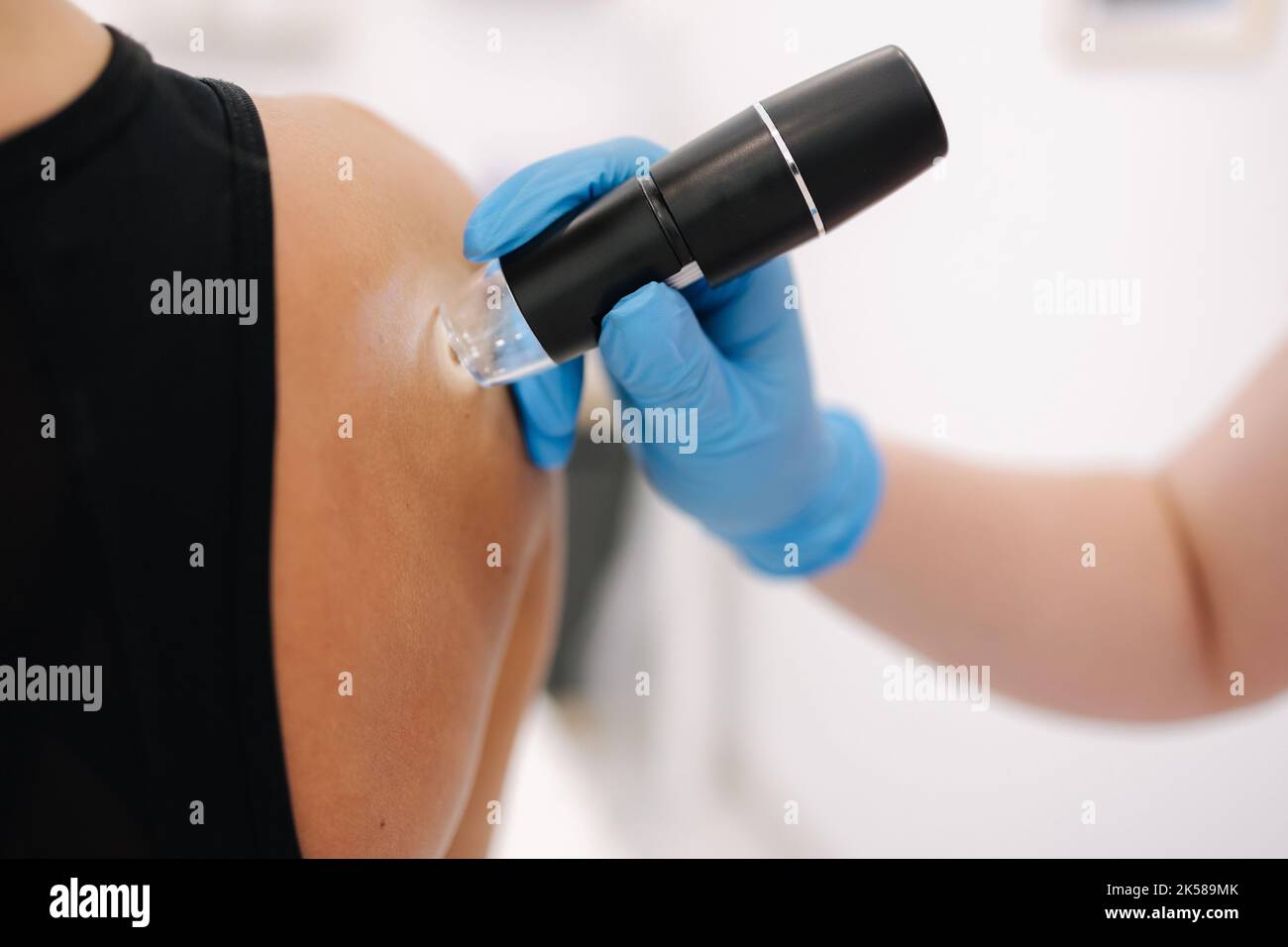 Doctor and female client in dermatology clinic. Macro photo of ...