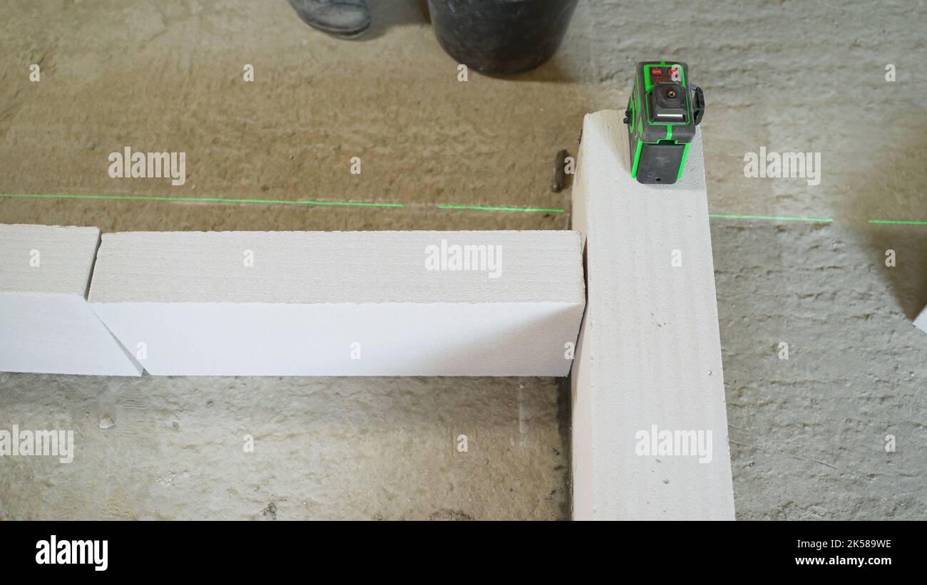 Construction of walls from aerated concrete blocks. Builders lay ...