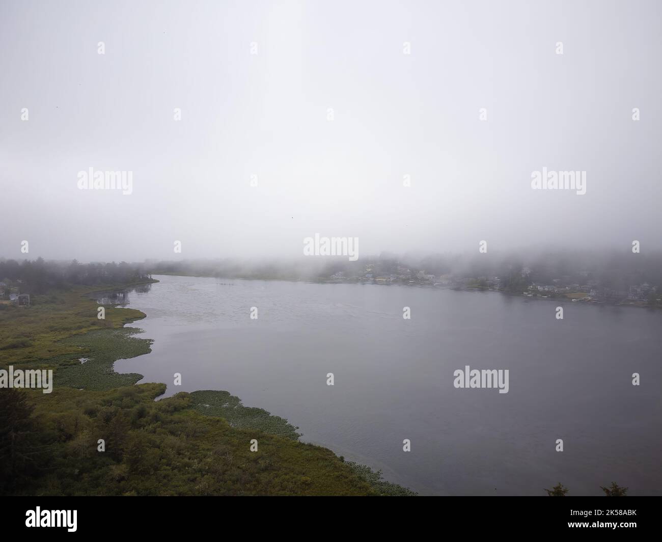 Beautiful nature. Big river and green banks. Twilight, light fog. The ...