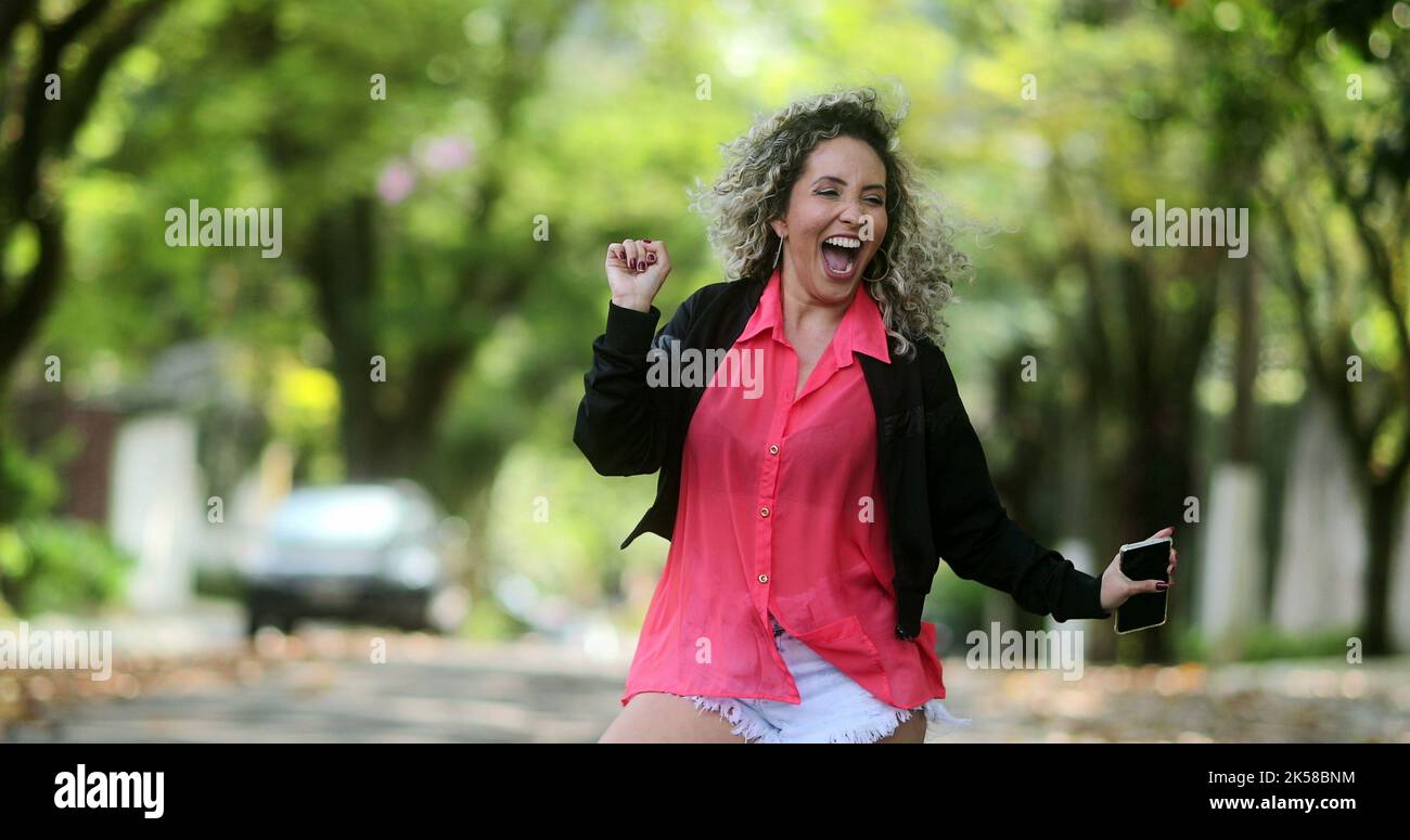 Happy woman dancing with joy and freedom, carefree extroverted person ...