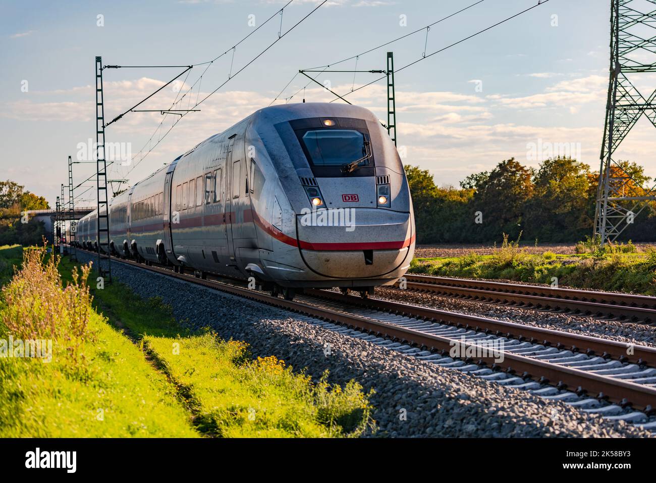A rail line with an ICE train passing through rural area, Germany Stock ...