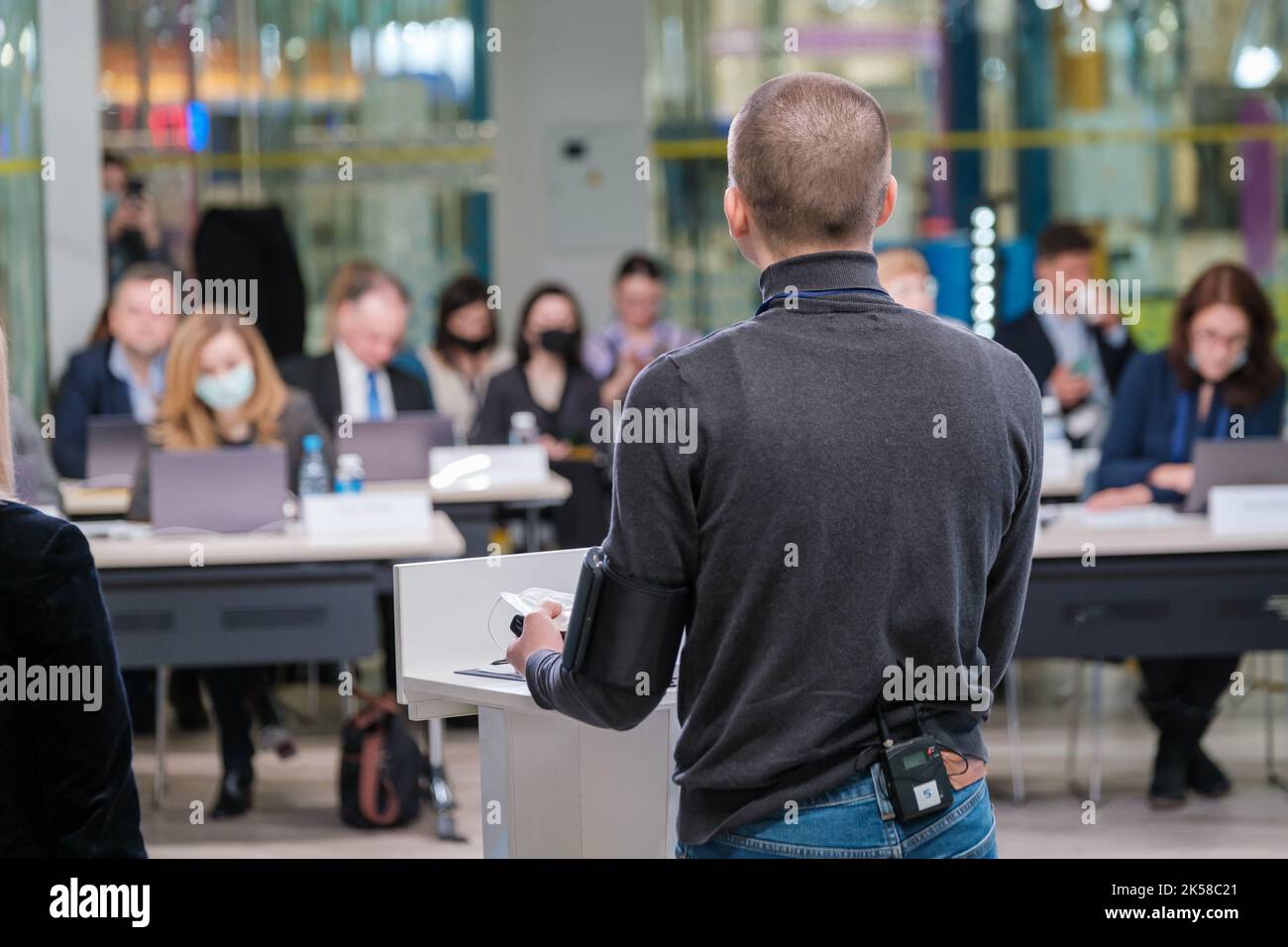 Anonymous man speaking during presentation with group of business ...