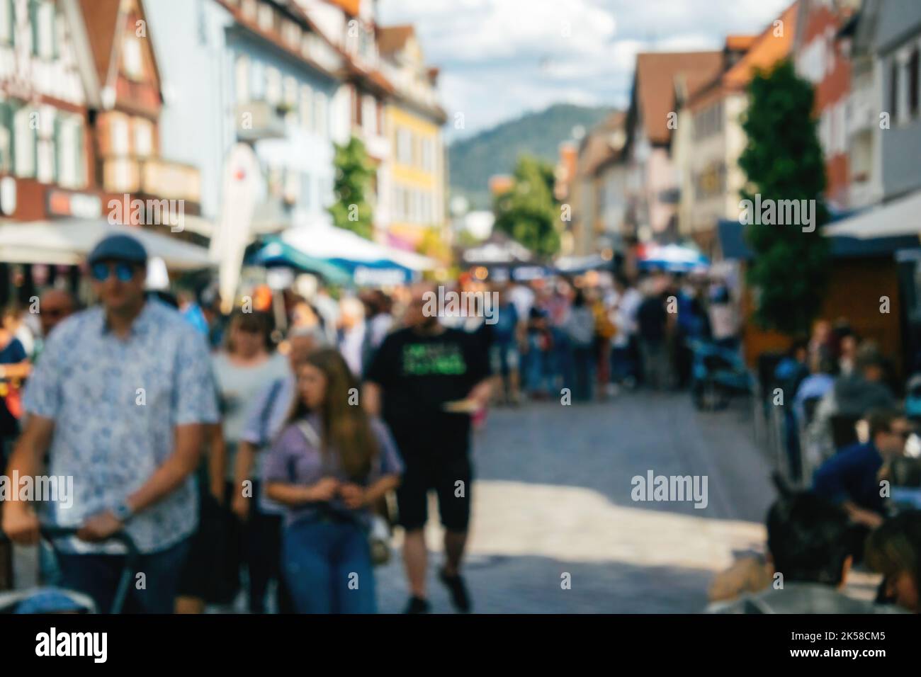 Crowd on busy street in German French italian Swiss village ...