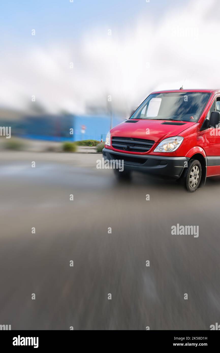 Fast red driving near warehouses and street red delivery van - large ...