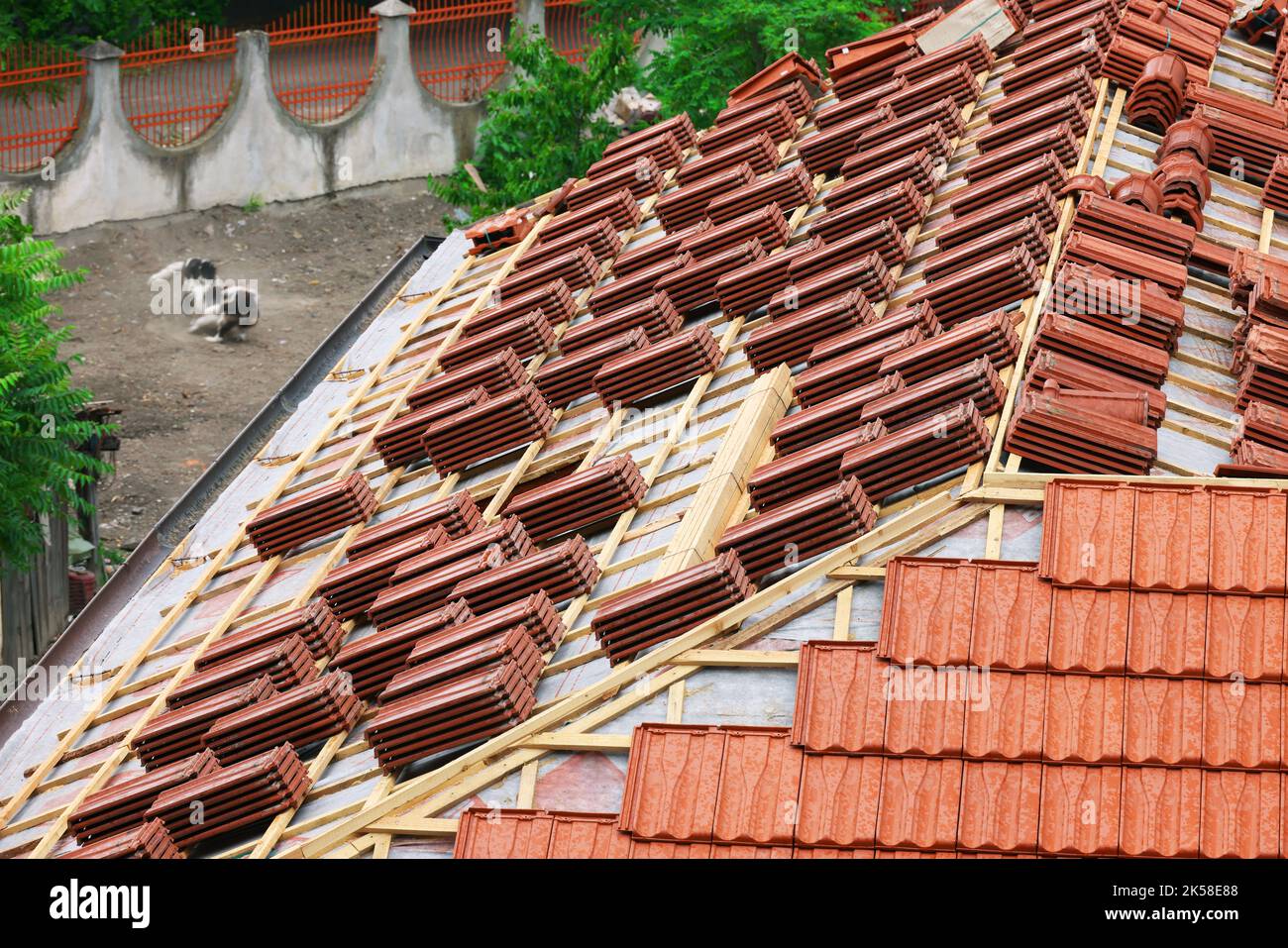 Roof building at new house construction. Brown roof tiles covering ...