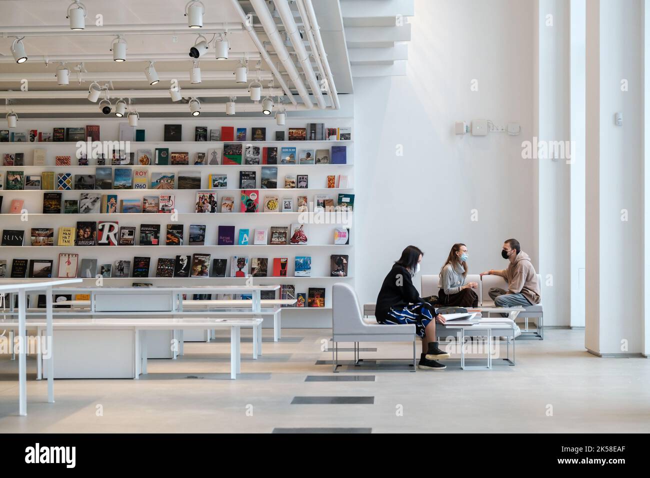 Women using devices in library Stock Photo - Alamy