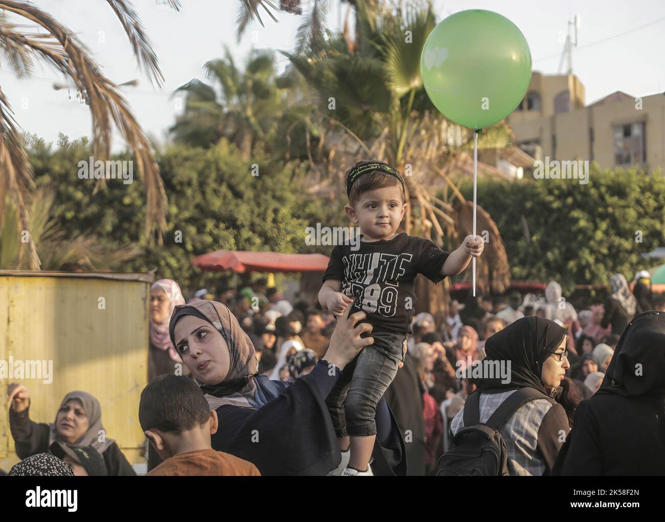 A Palestinian Islamic Jihad supporter with her kid attends the rally ...