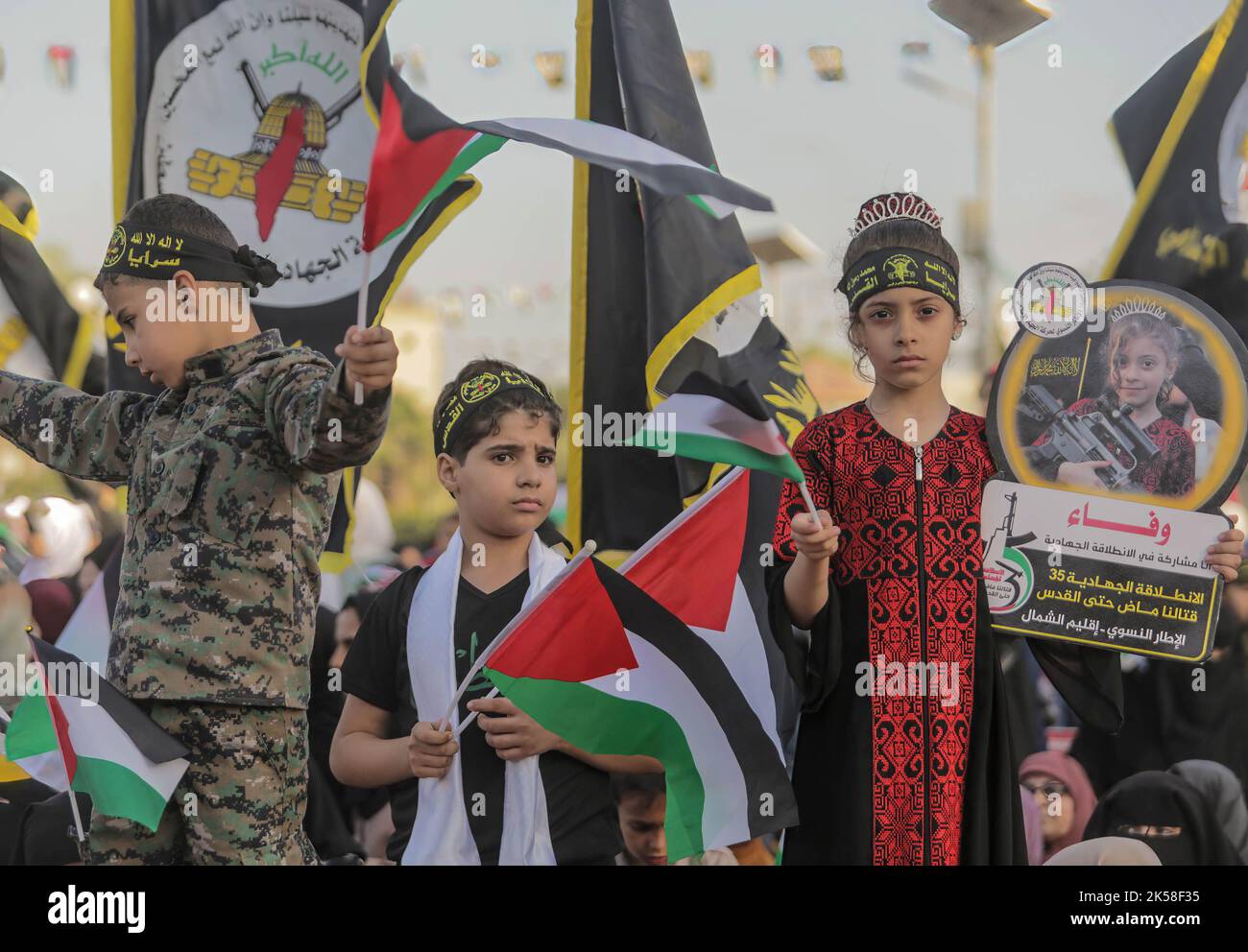 Palestinian Islamic Jihad child supporters hold flags as they attend ...