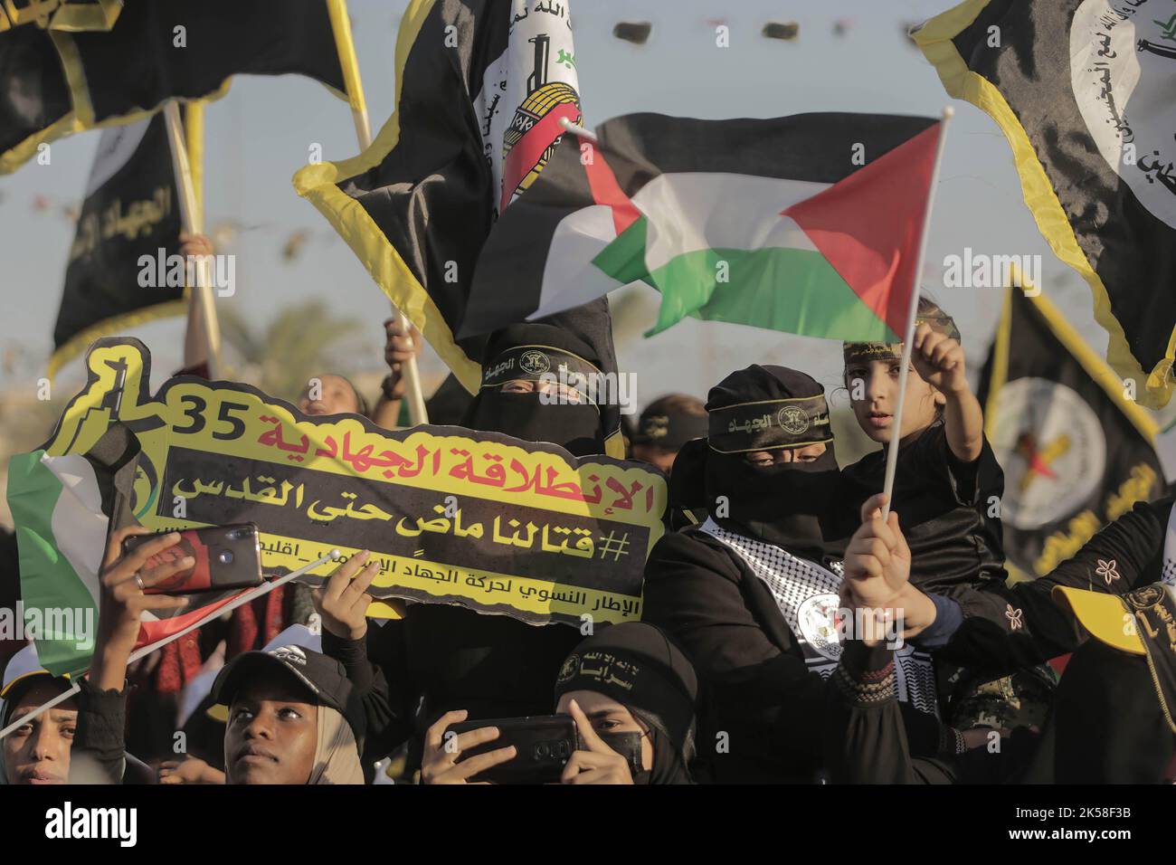 Palestinian Islamic Jihad supporters hold flags as they attend the ...