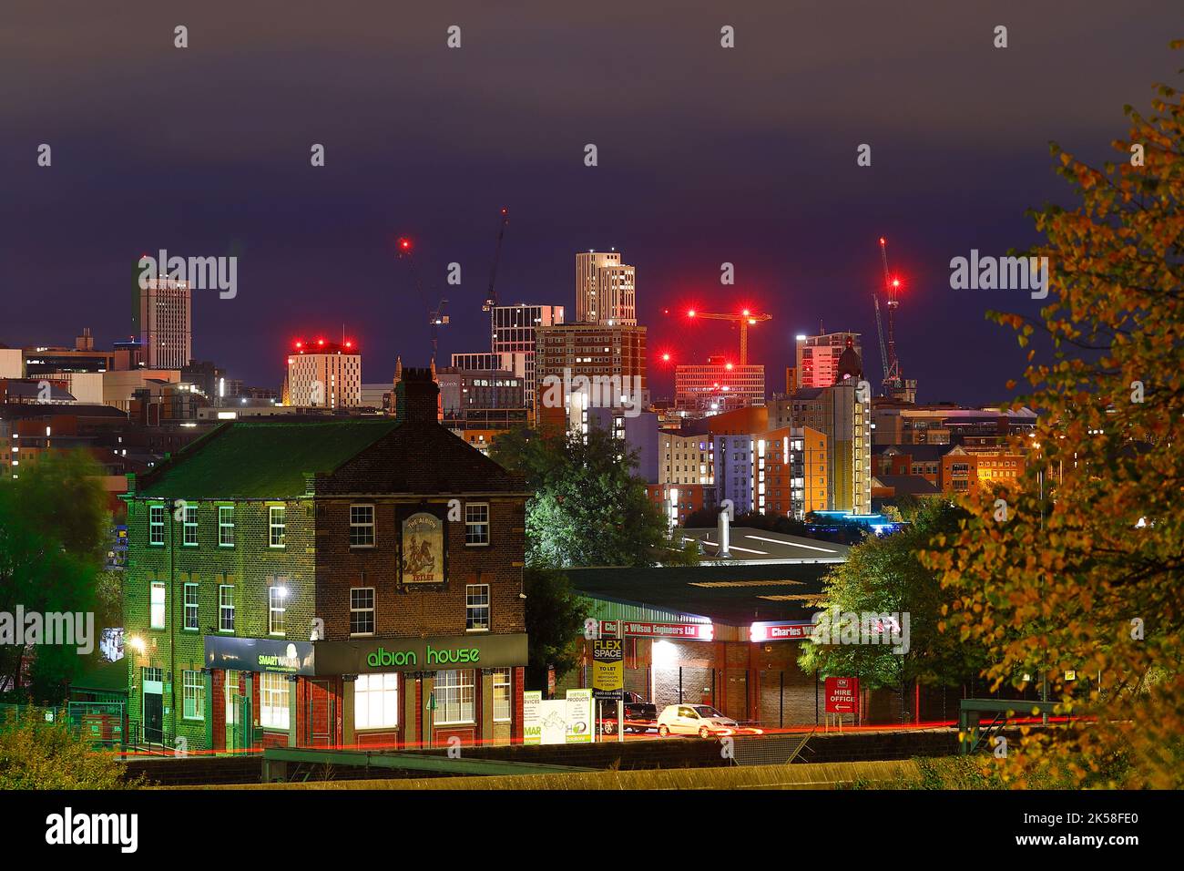 Leeds City Centre at night with tower cranes on various developments ...