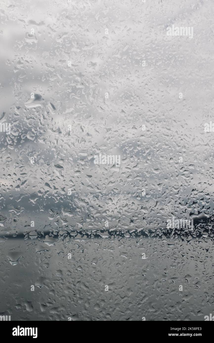 rain drops water on Pacific Northwest ferry boat window looking out at ...