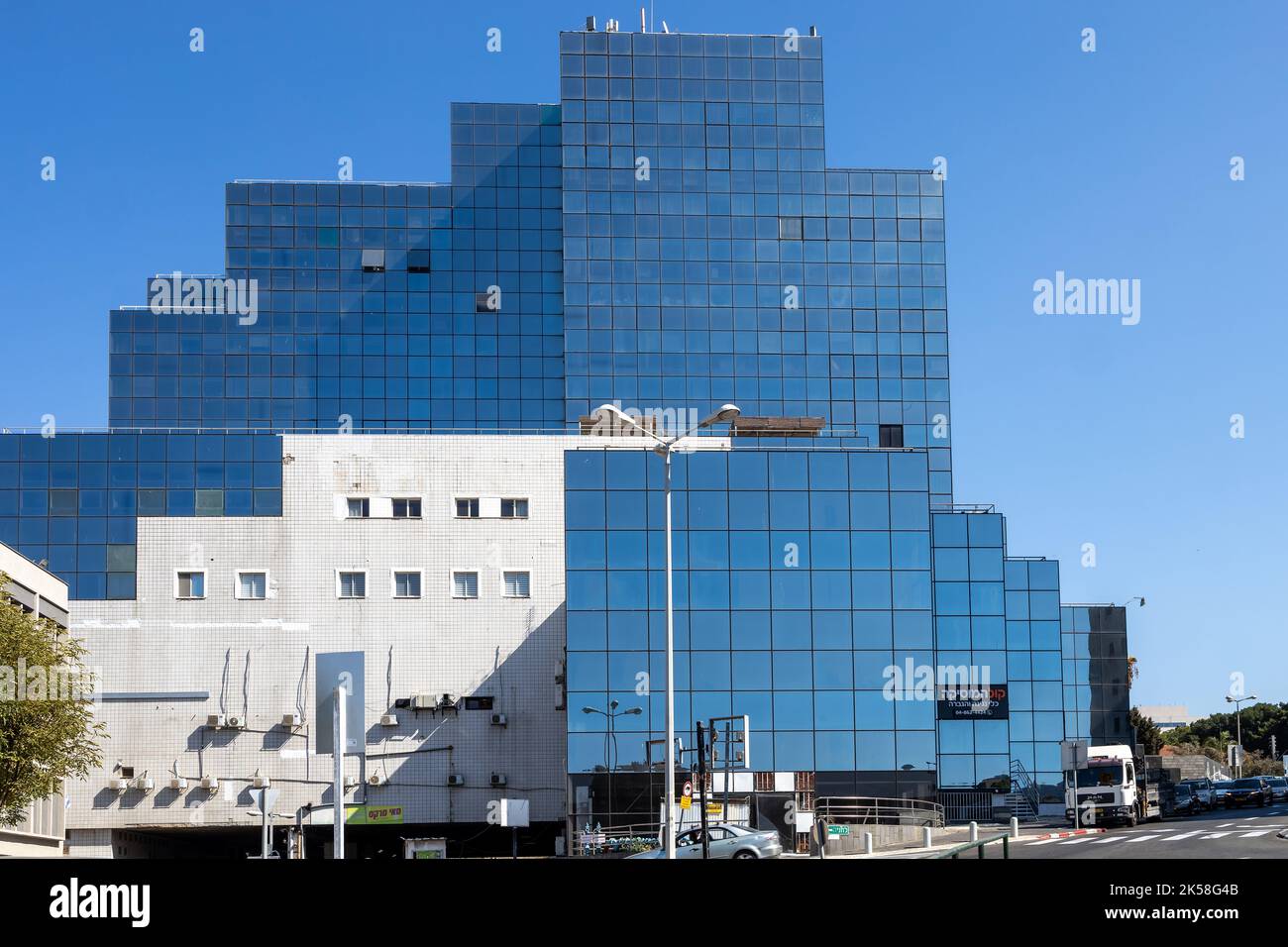 Haifa, Israel - September 2022, high-rise building with "black shekem ...