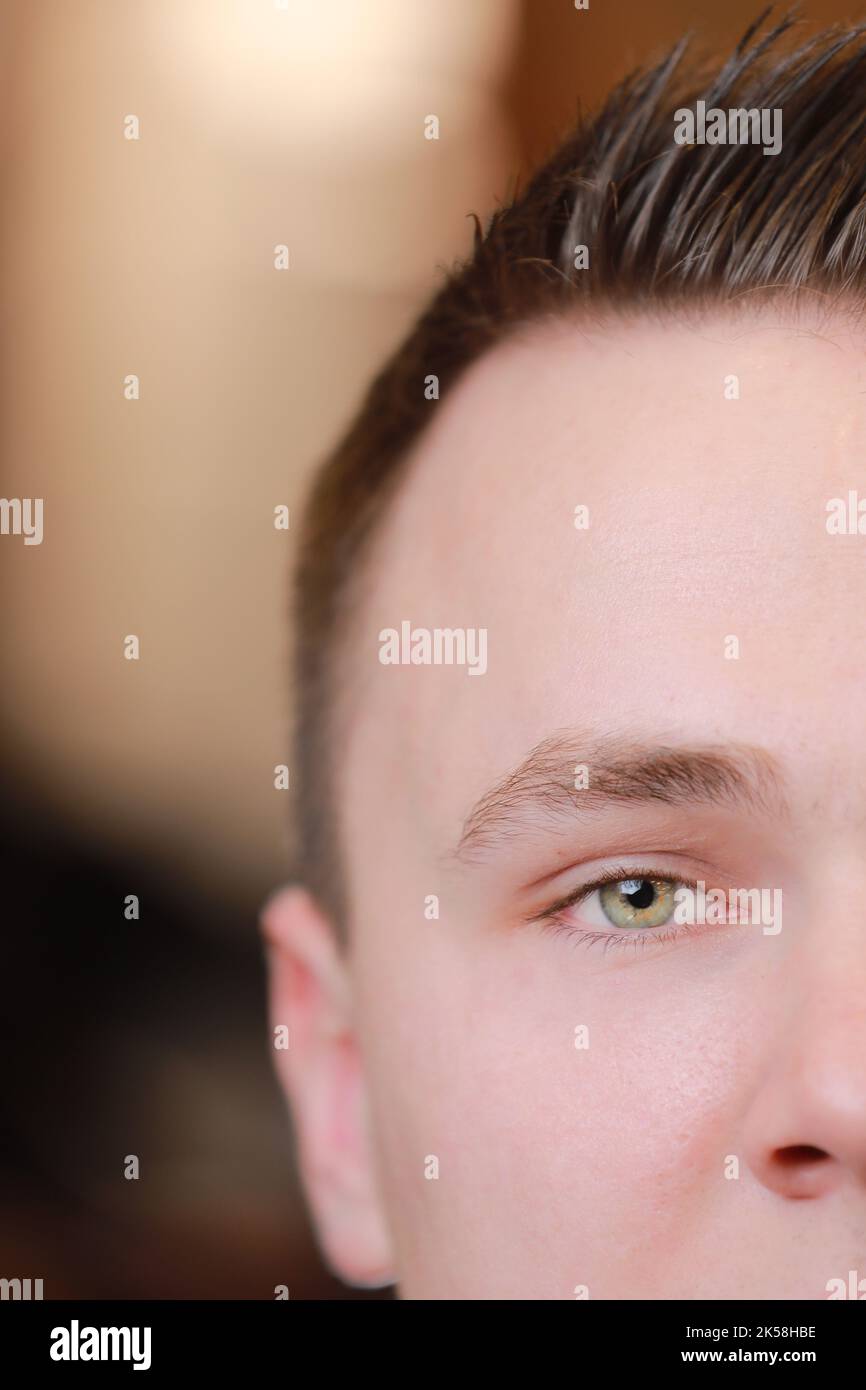 half face portrait of serious concentrated confident handsome young ...