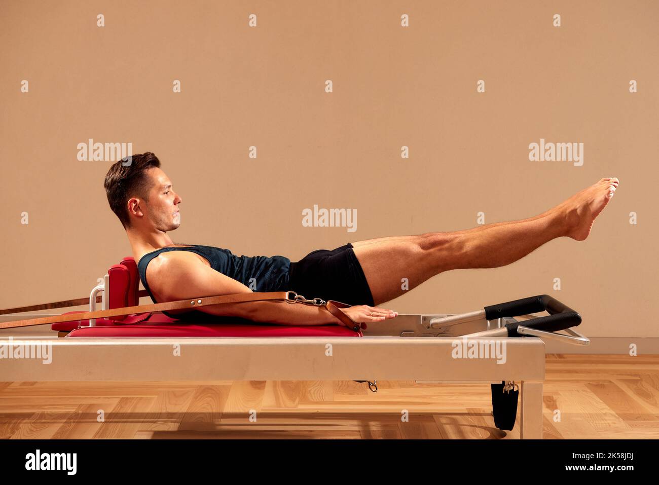 Fit man doing a lunge stretch yoga pilates exercise to strengthen and ...
