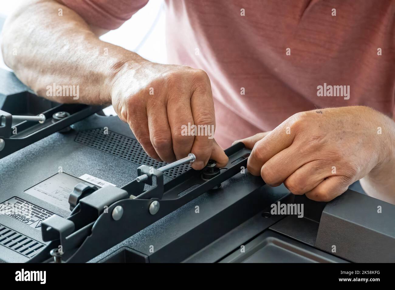 man installing the wall base for the television, it is a smart tv ...