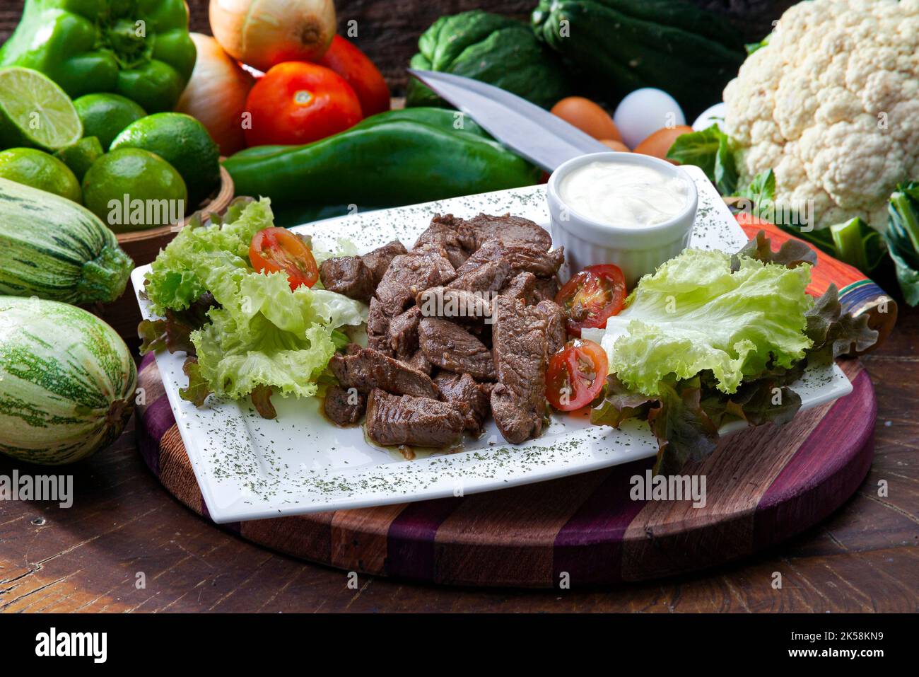 Filet mignon with salad and white sauce isolated Stock Photo - Alamy