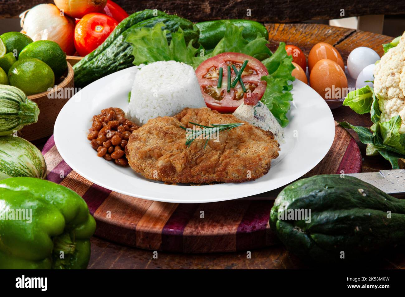 Breaded Steak with Rice and Beans Salad Stock Photo - Alamy