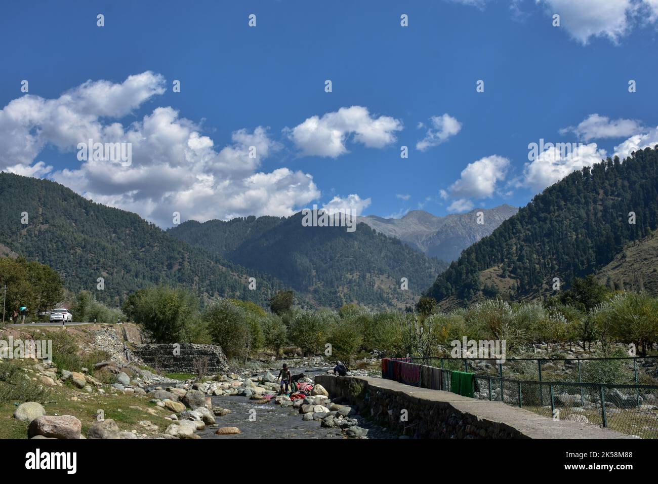 Kashmiri villagers wash clothes at a stream on a sunny day in Daksum ...