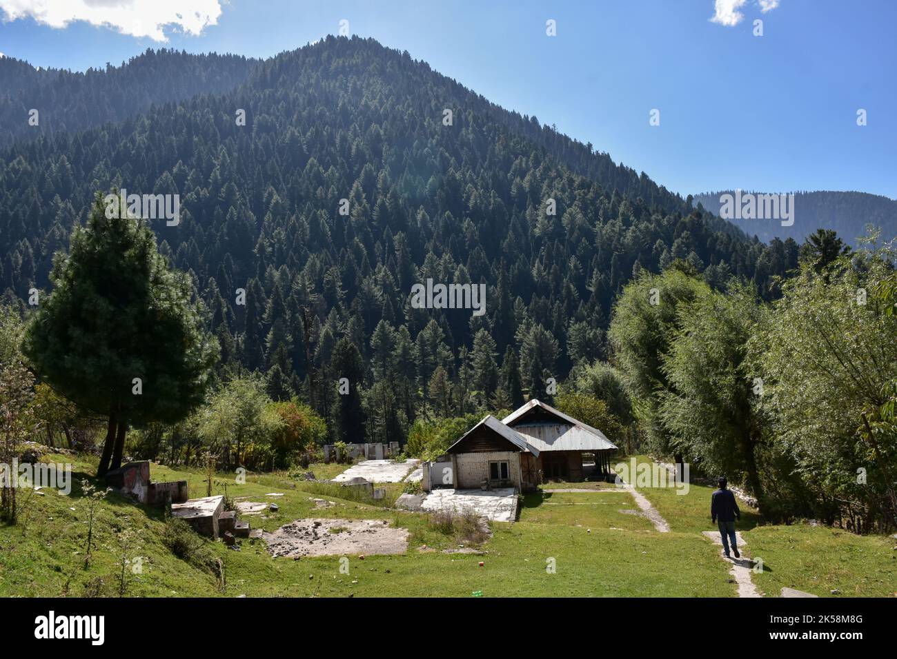 A visitor walks towards a hut in Daksum, about 100kms, south of ...