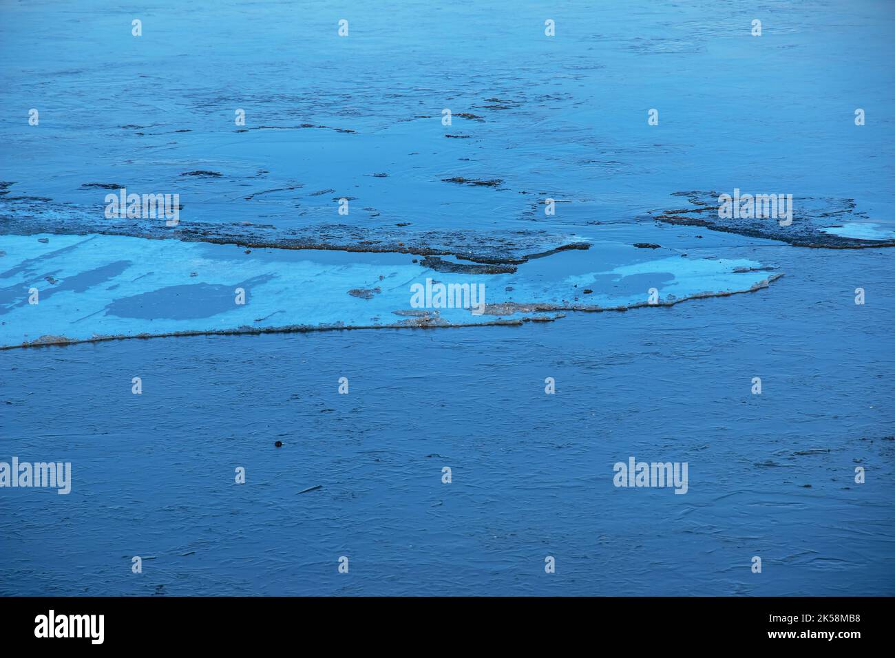 Winter nature background with blocks of ice on frozen water in spring ...
