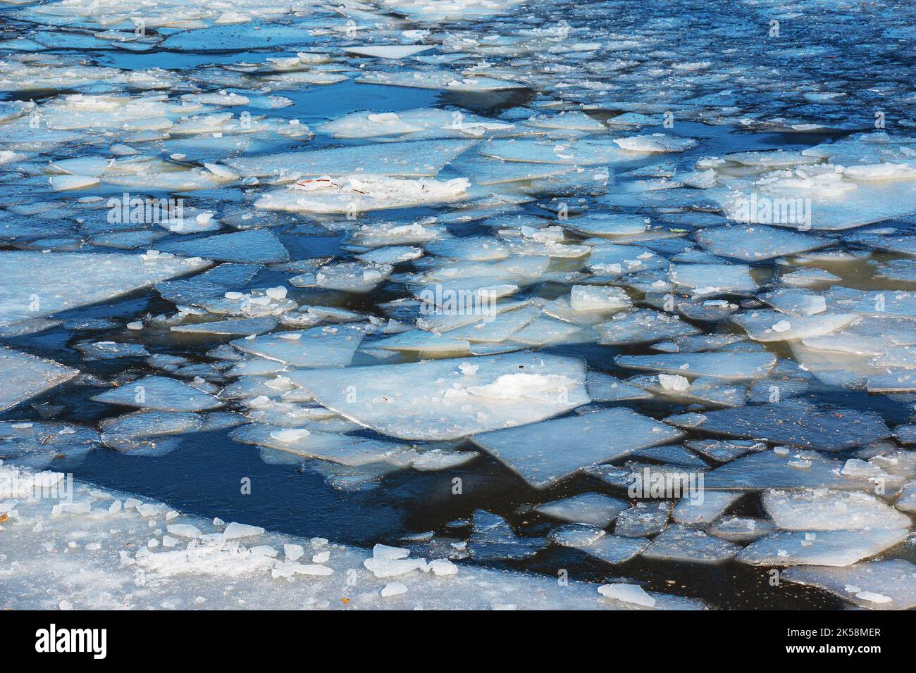 Winter nature background with blocks of ice on frozen water in spring ...
