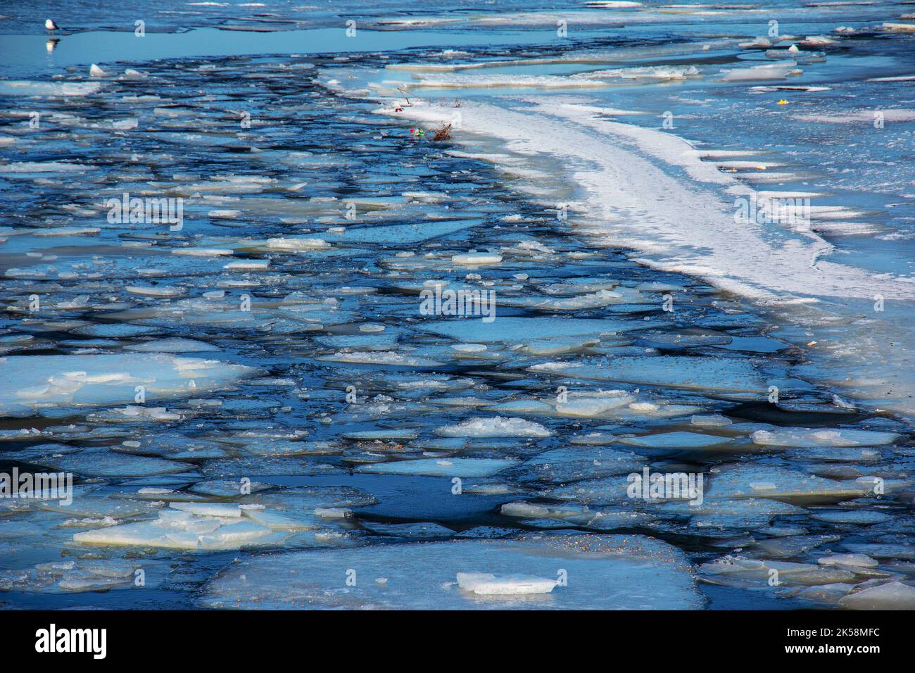 Winter nature background with blocks of ice on frozen water in spring ...